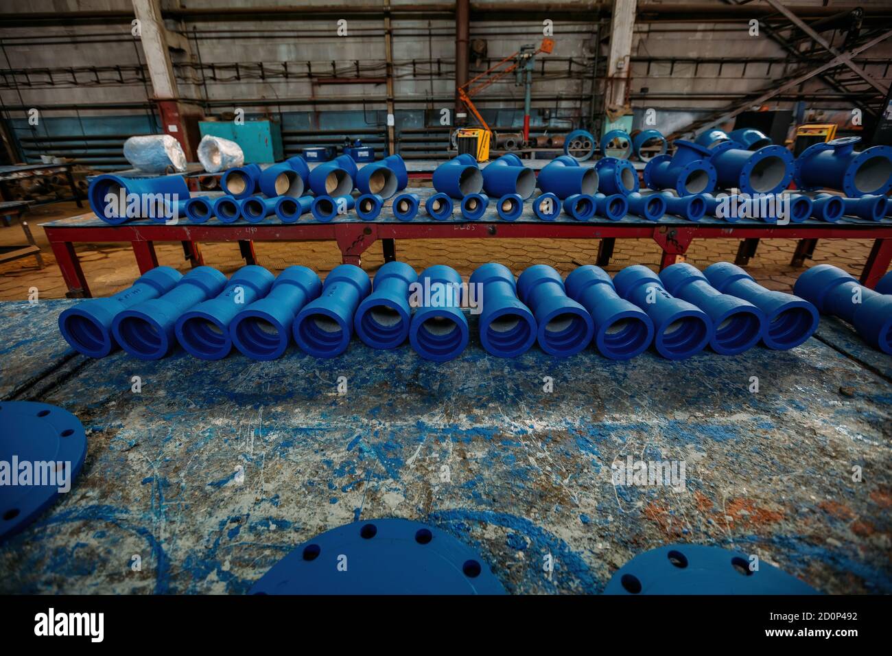 Cast metal blue pipe connection parts at workshop Stock Photo - Alamy