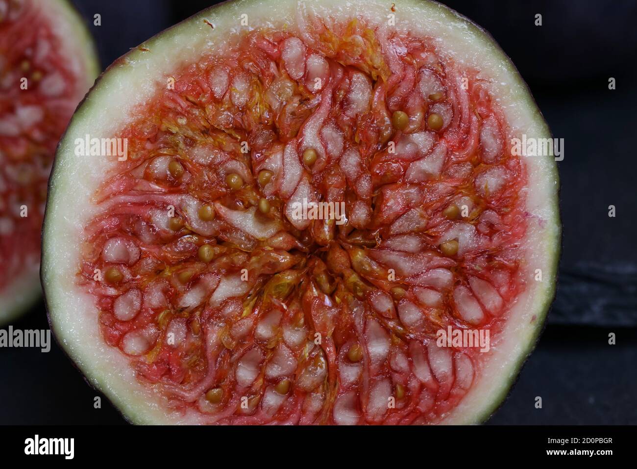 Macro closeup of isolated fresh ripe sliced half fig fruit Stock Photo ...