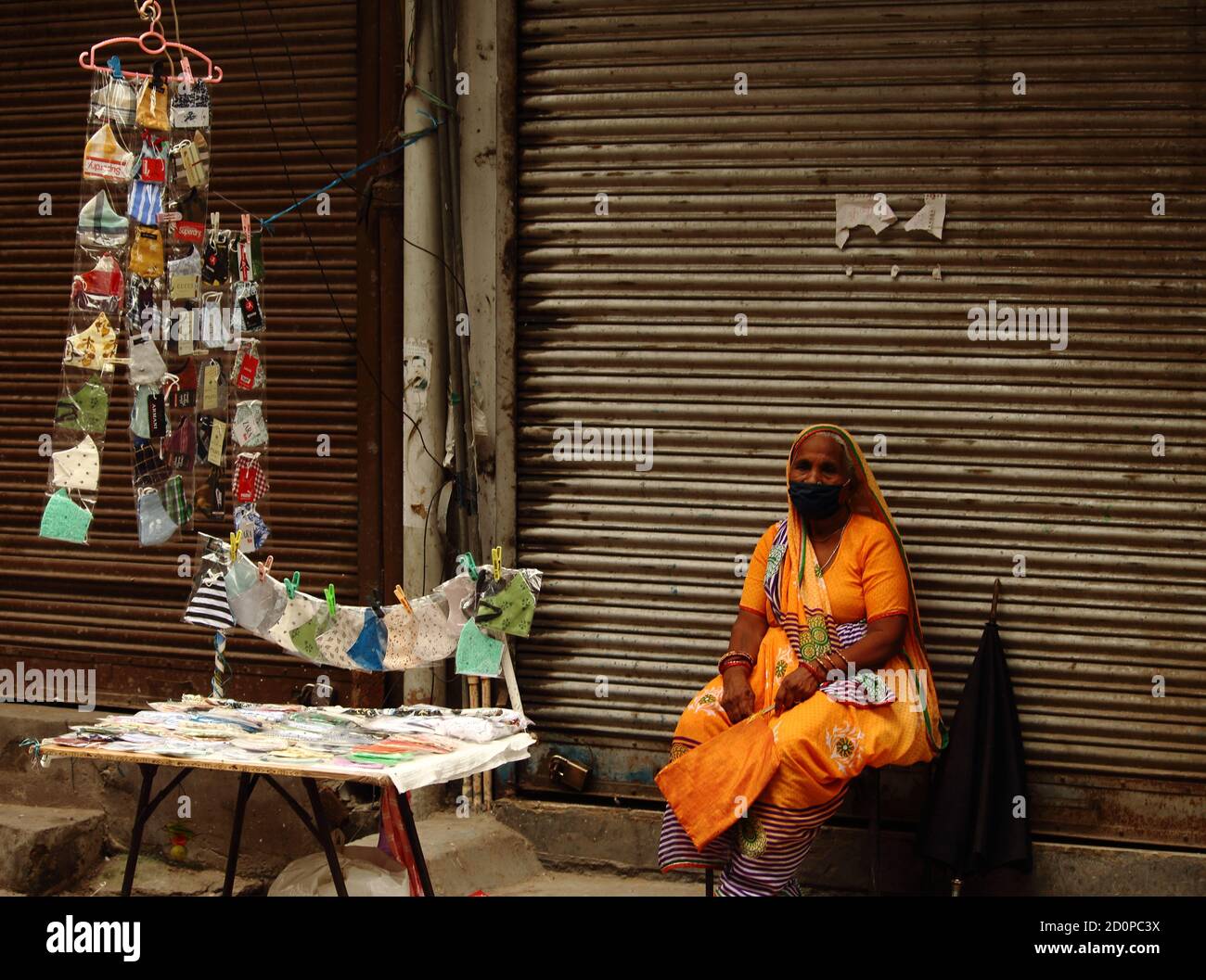 Old Woman is selling masks for livelihood after pandemic in India Stock ...