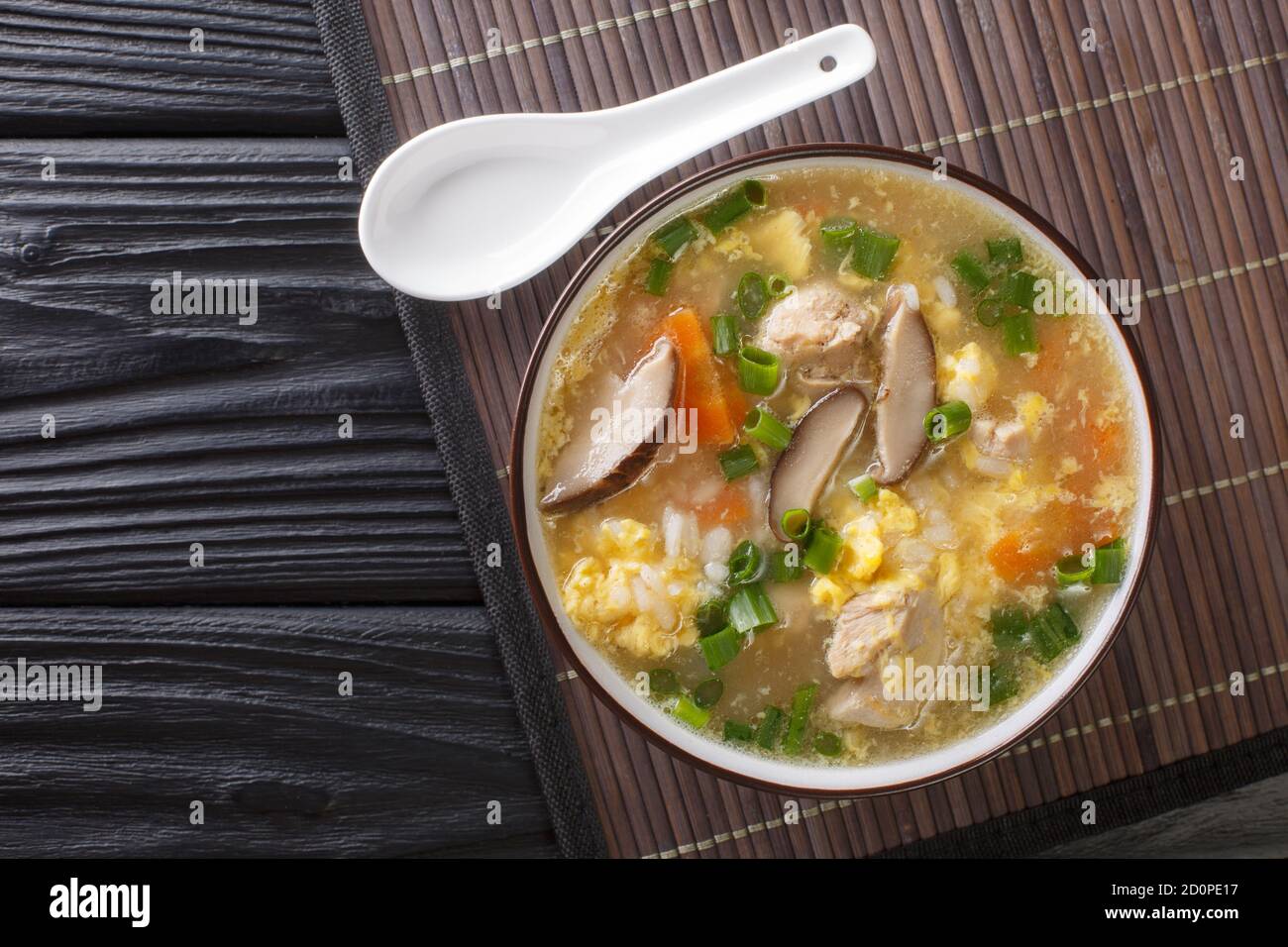 Fragrant Japanese thick rice soup Zosui with egg, mushrooms, vegetables ...