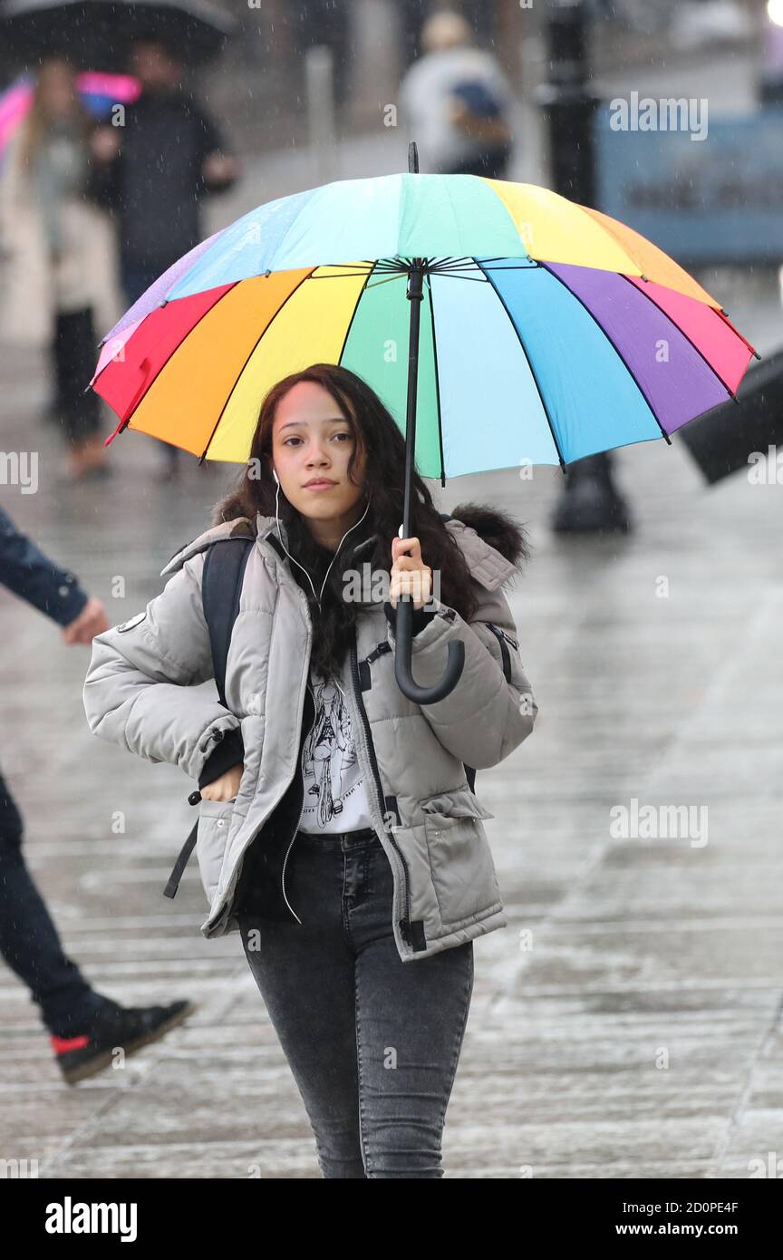 People walk through rain in Nottingham city centre, as heavy rain is ...