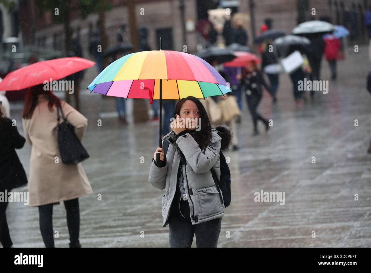 People walk through rain in Nottingham city centre, as heavy rain is ...