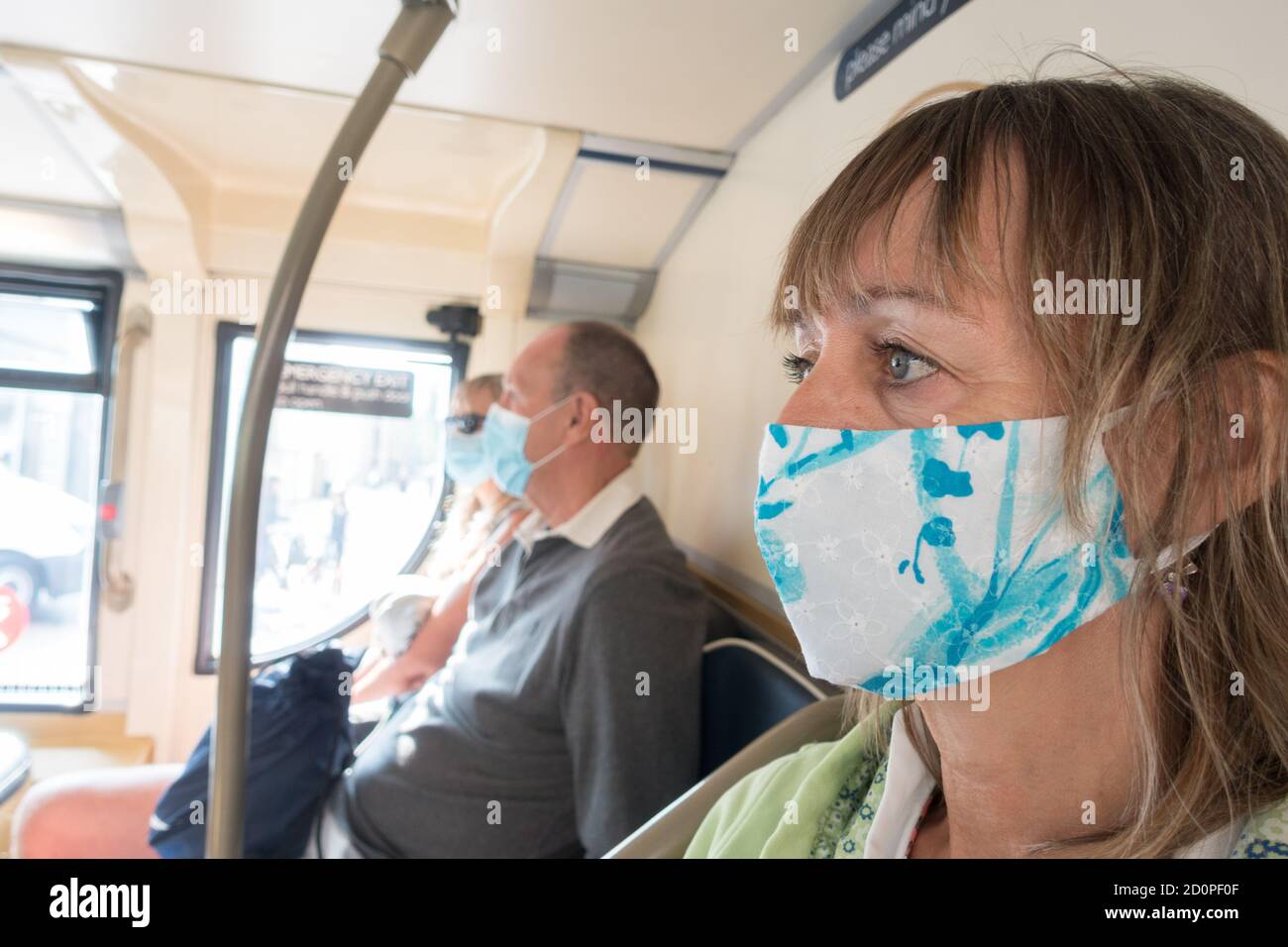 Bus passenger wearing face covering hi-res stock photography and images ...