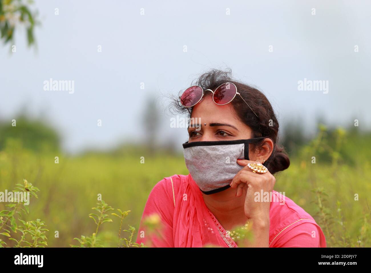 An Indian young stylish female model posing in a field wearing a brown ...
