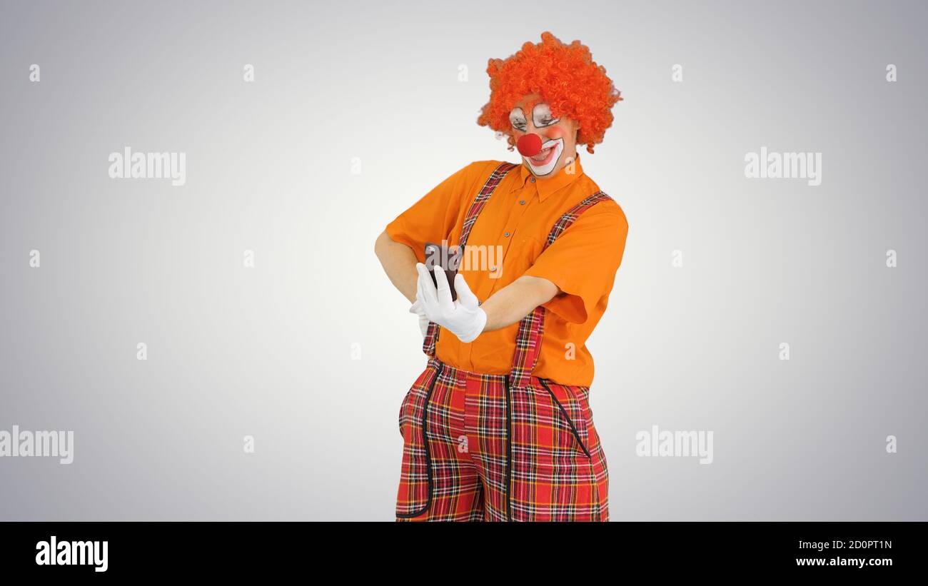 Clown taking selfie with his phone on gradient background Stock Photo ...