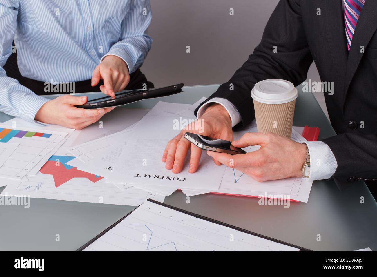 Two business people analyzing income charts at office Stock Photo - Alamy