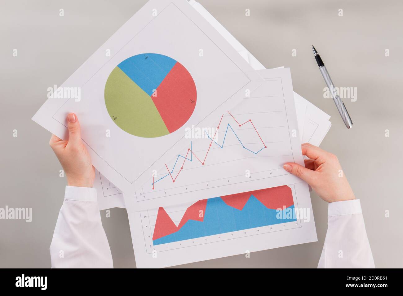 Woman working with financial charts and graphs Stock Photo - Alamy