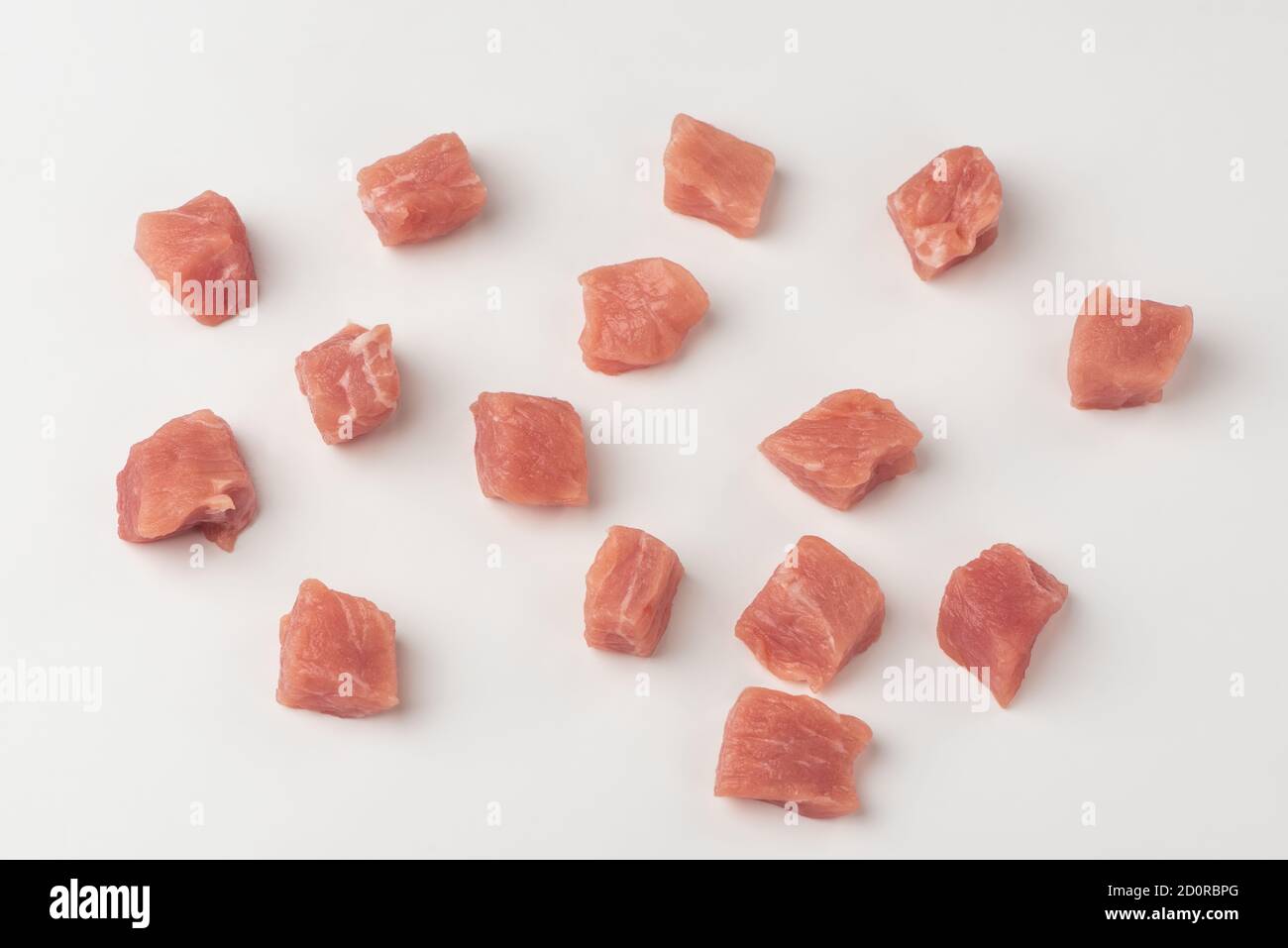 Fresh pork diced into small cubes on white background. Cooking g Stock ...