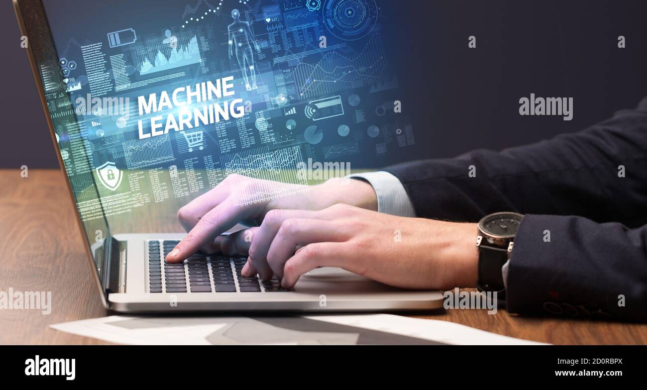 Businessman working on laptop with MACHINE LEARNING inscription, cyber ...