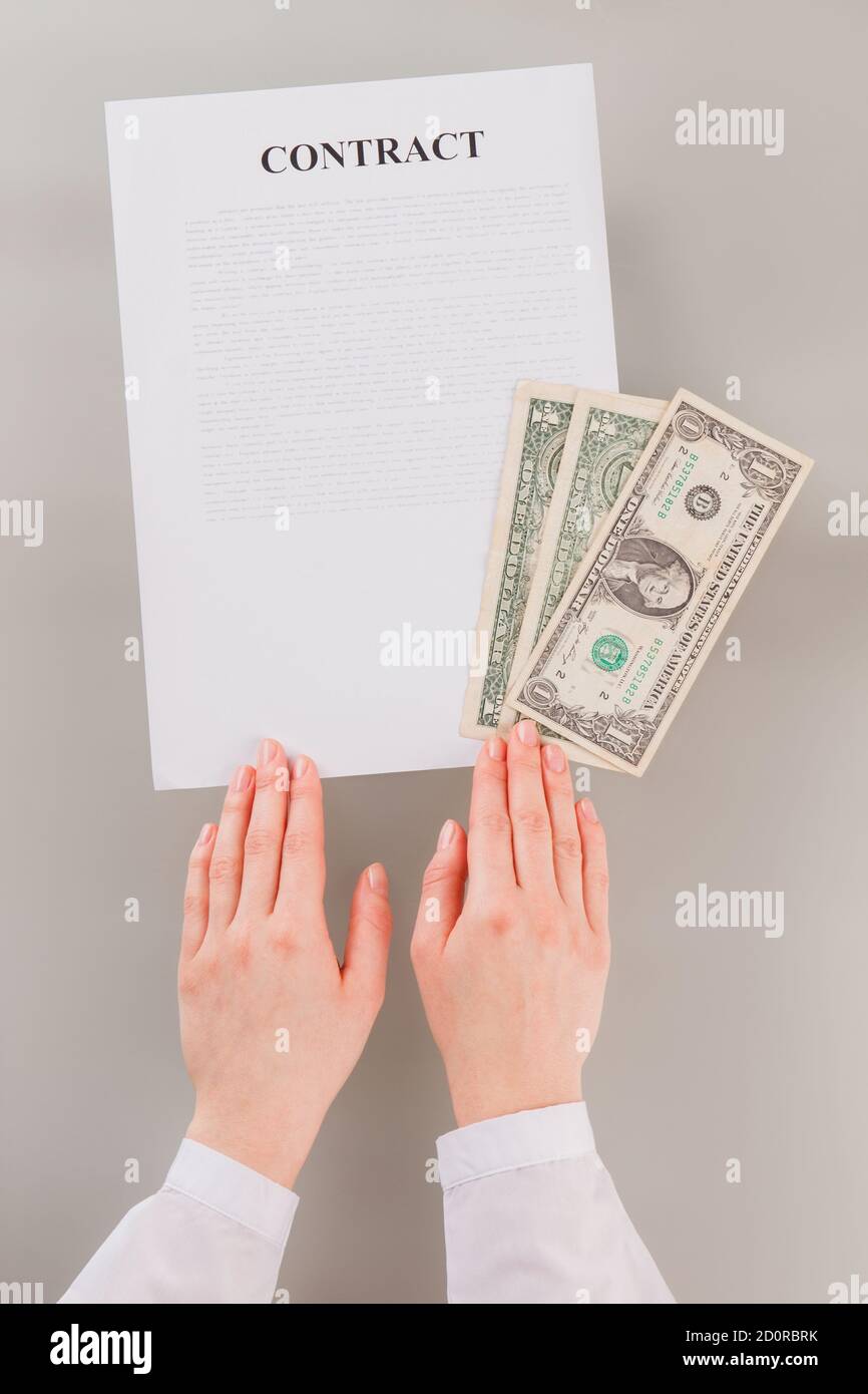 Money, contract and female hands on the table Stock Photo - Alamy