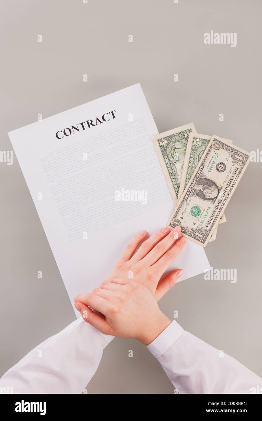Top view of female hands, contract and money Stock Photo - Alamy