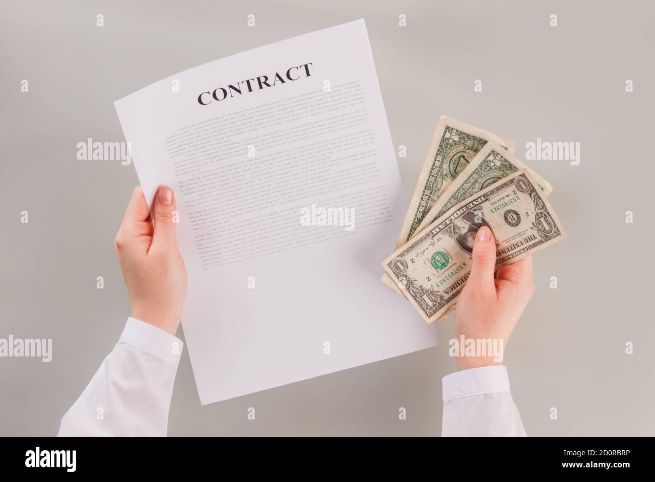 Document and money in womans hand Stock Photo - Alamy