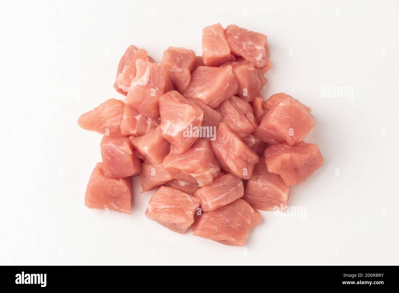 Top view on a heap of pork loin cut into cubes on white backgrou Stock ...