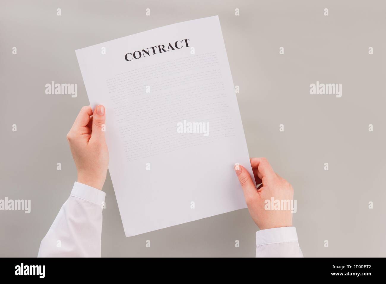 Female hands holding contract letter Stock Photo - Alamy