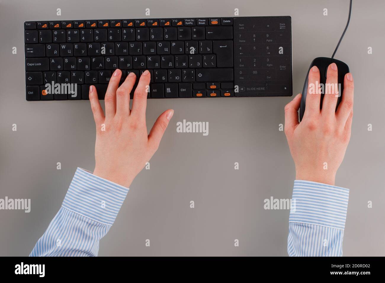 Female hands using computer keyboard and mouse Stock Photo - Alamy