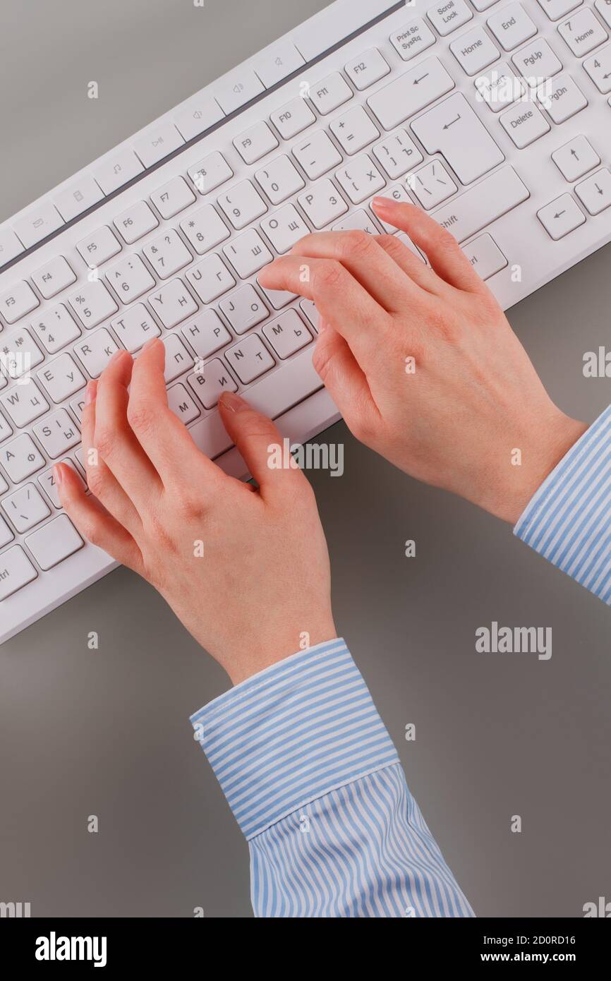 Office woman is typing on computer keyboard close up Stock Photo - Alamy