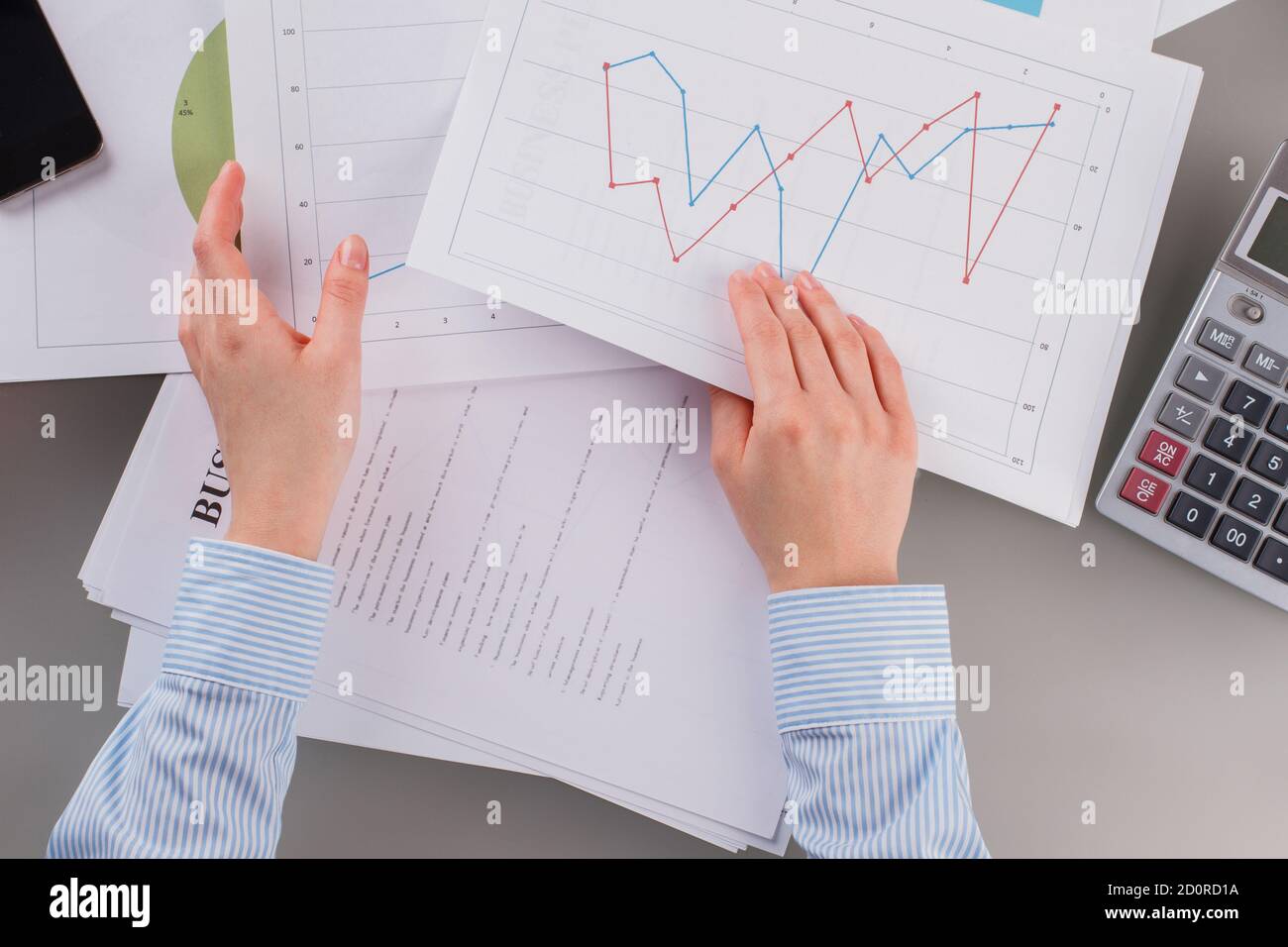Financial analyst analysing graphs and charts at office desk Stock ...