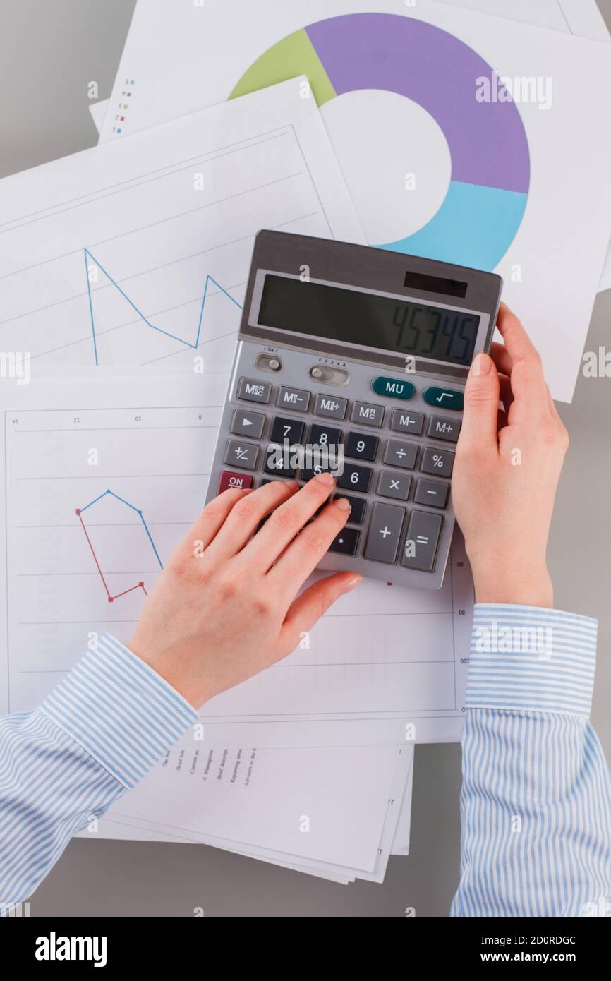 Top view female accountant using calculator Stock Photo - Alamy