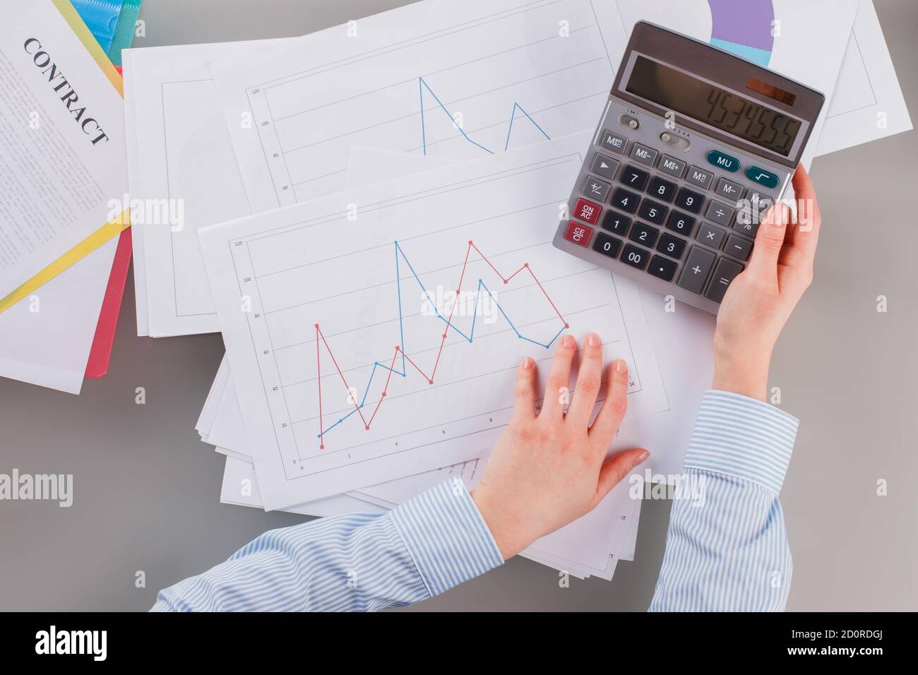Female accountant using calculator in office Stock Photo - Alamy