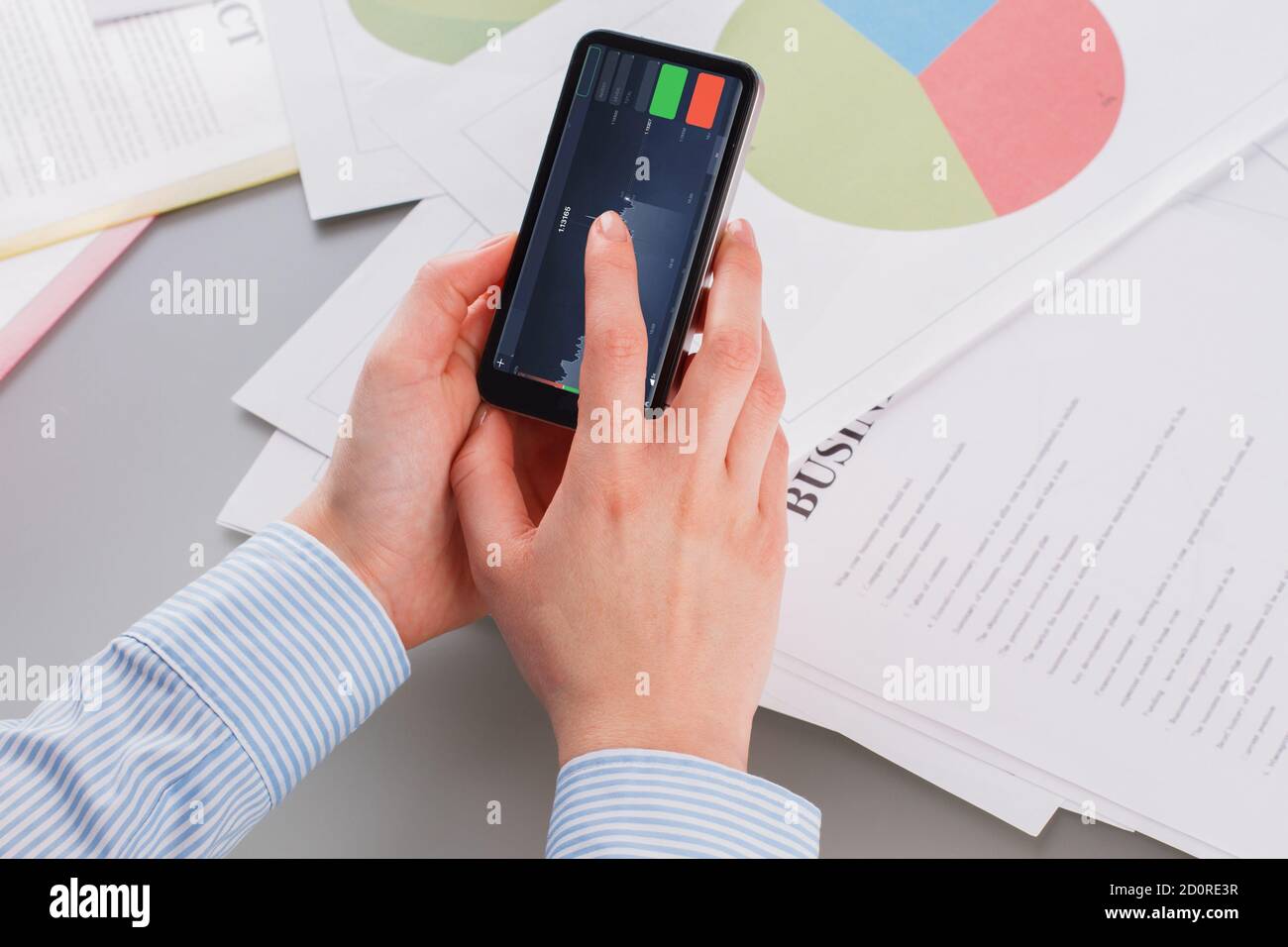 Hands using smartphone against strategic documents Stock Photo - Alamy