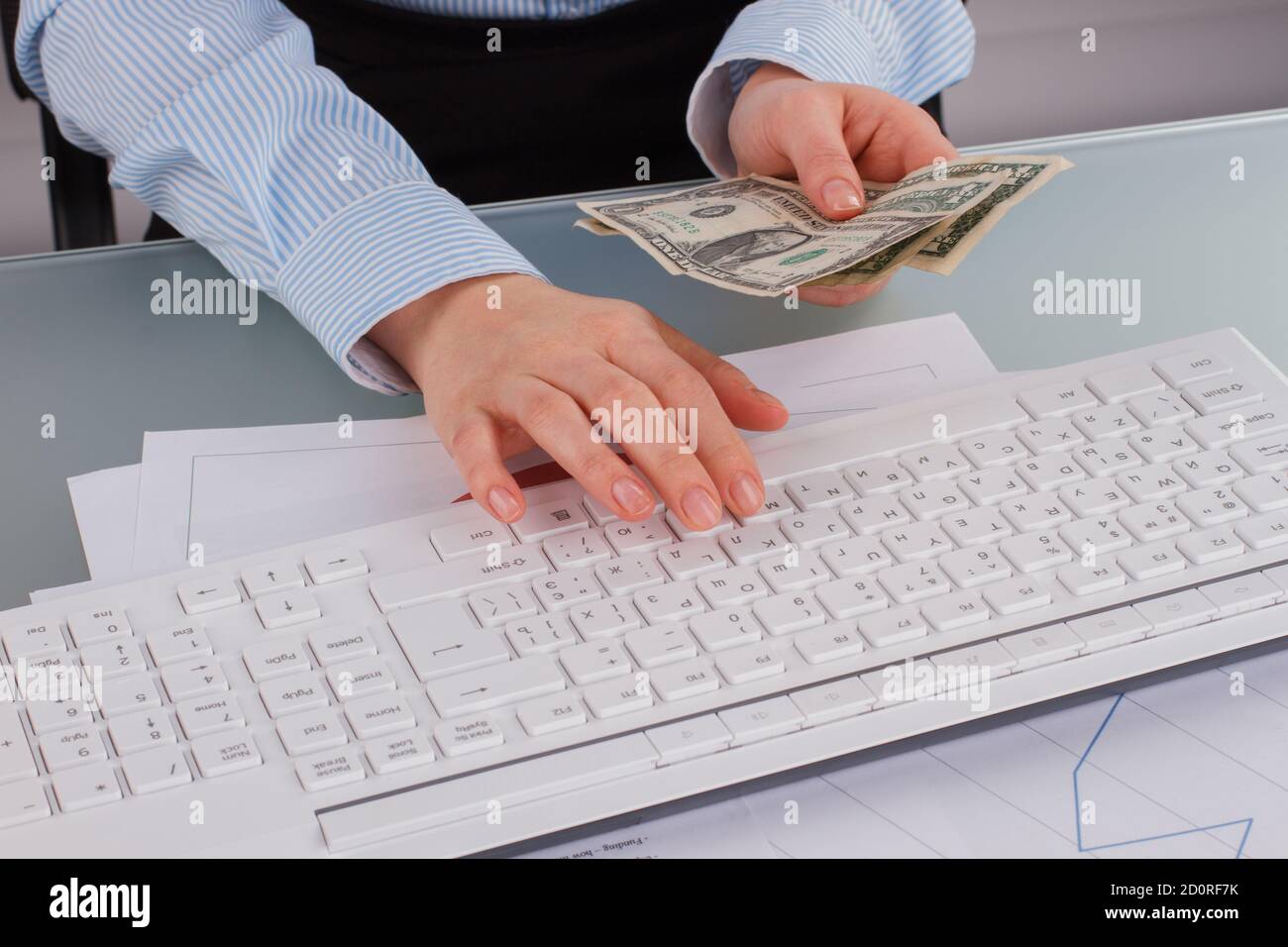Female hands holding money while typing on computer keyboard Stock ...