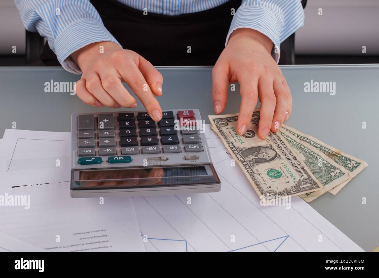 Female accountant working with calculator at office Stock Photo - Alamy
