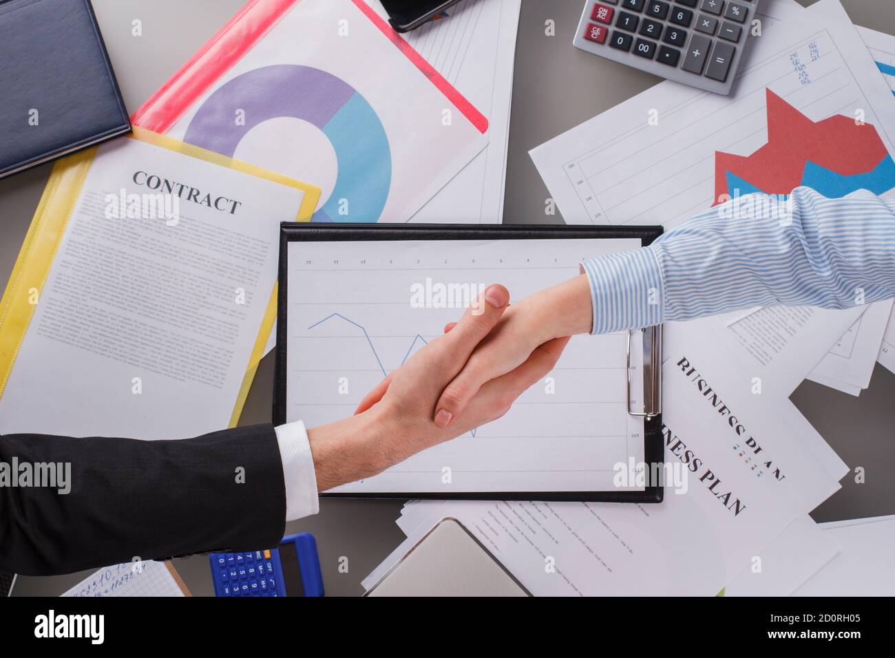 Business people shaking hands over office desk Stock Photo - Alamy