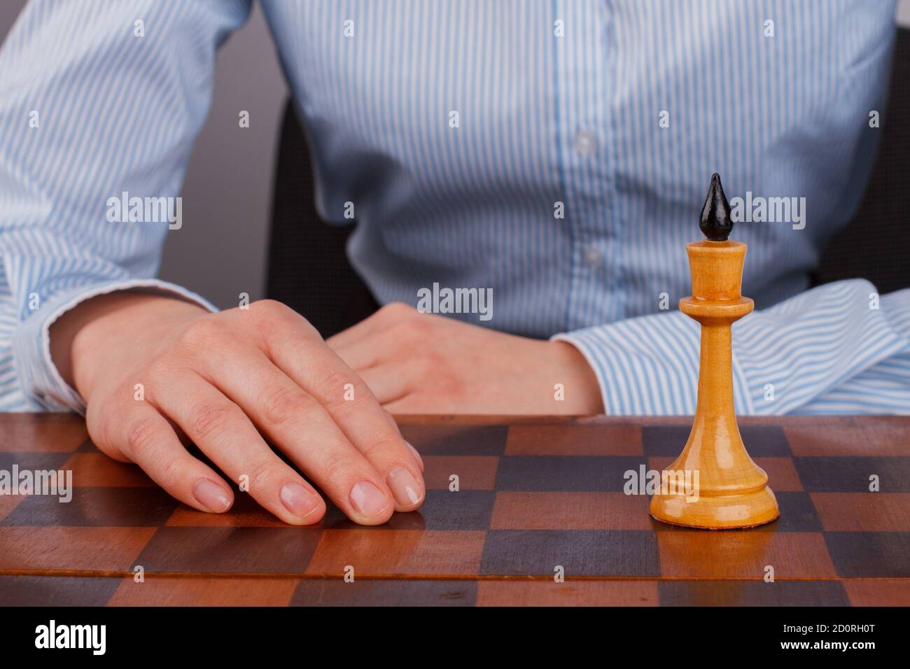 Female hand and chess figure on chess board Stock Photo - Alamy
