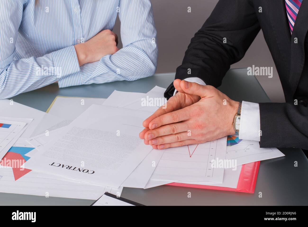 Two business people negotiating sitting at table in office Stock Photo ...