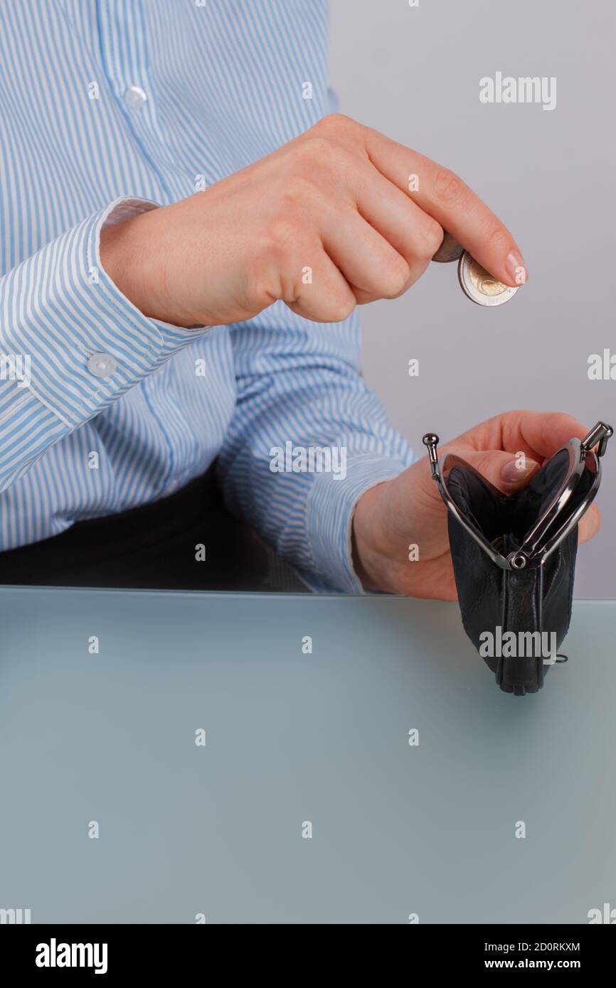 Putting coin money bag hi-res stock photography and images - Alamy