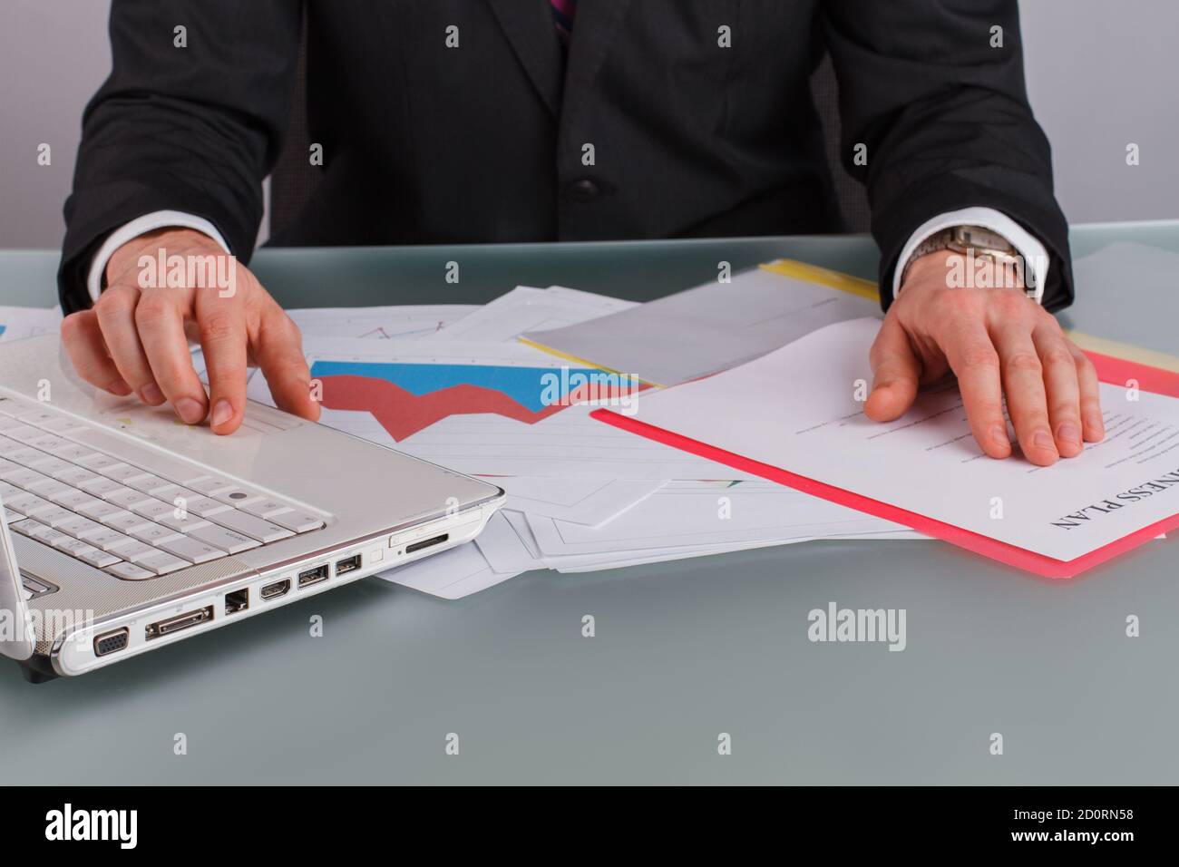 Businessman working with laptop and financial documents close up Stock ...