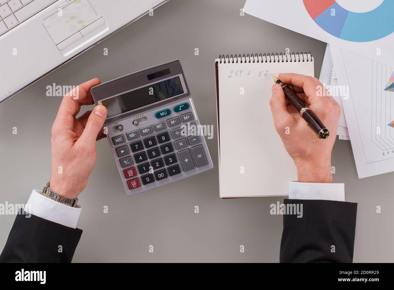 Male accountant calculating and analyzing financial graphs data Stock ...