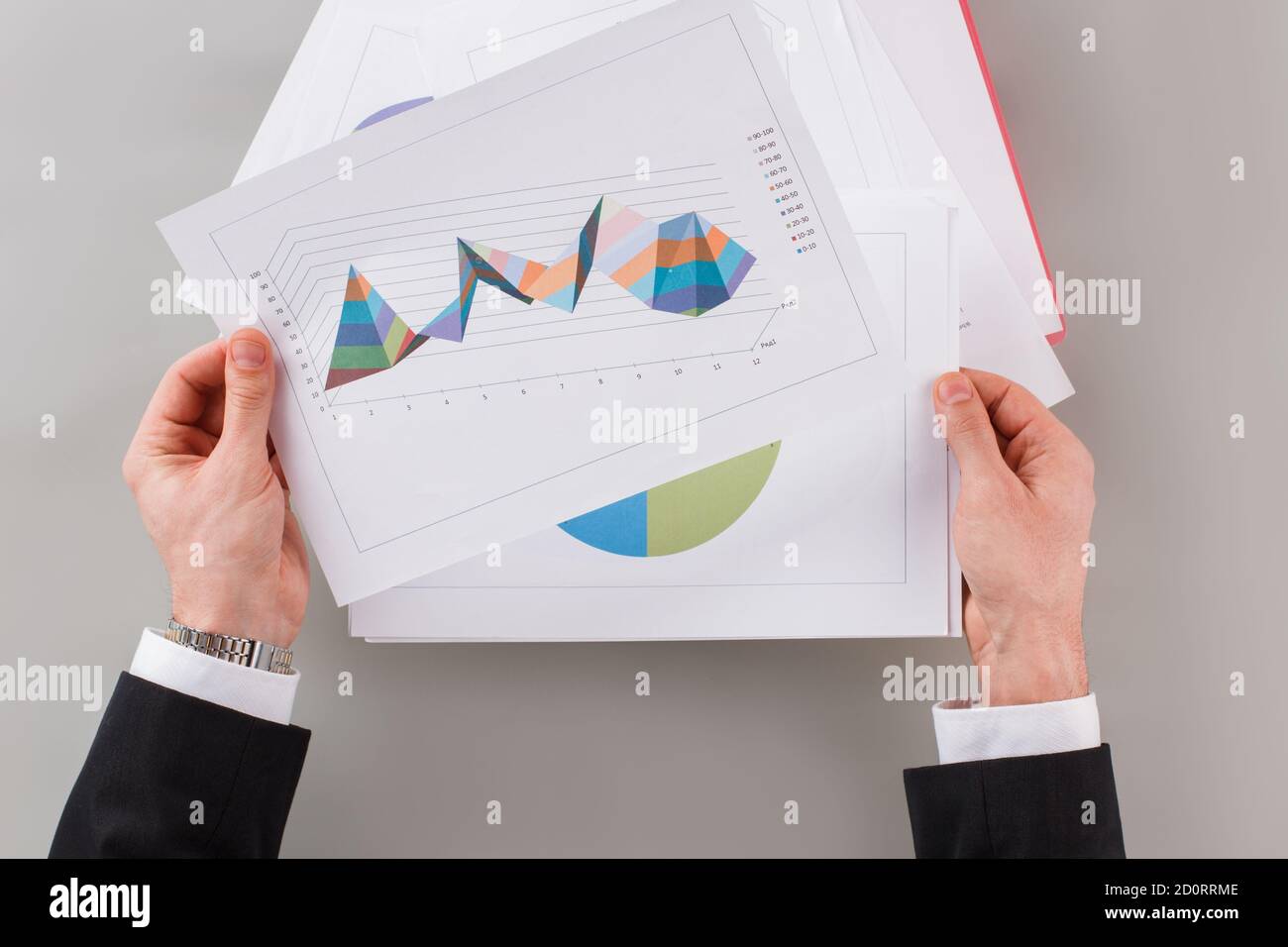 Businessman reviewing data in financial charts and graphs Stock Photo ...