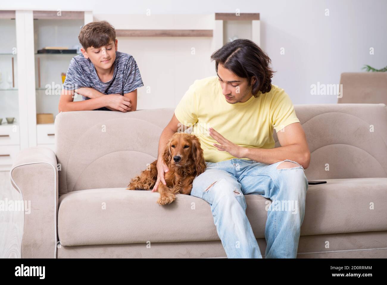 Young father and son with cocker spaniel dog Stock Photo - Alamy