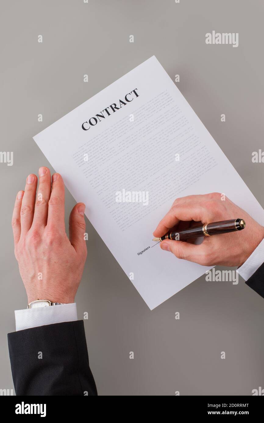 Top view of male executive signing a business contract Stock Photo - Alamy