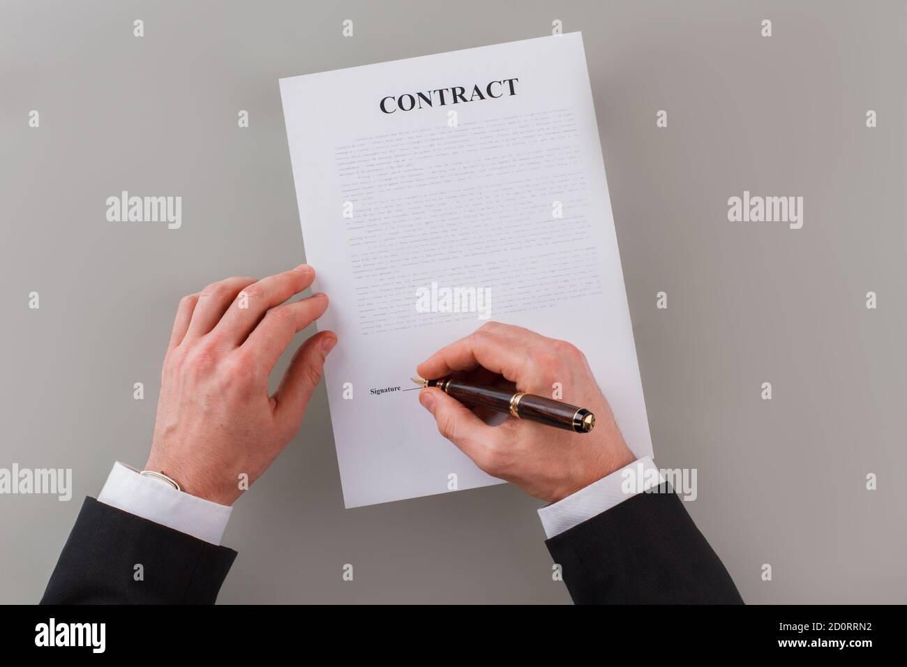 Close up businessman signing business papers Stock Photo - Alamy