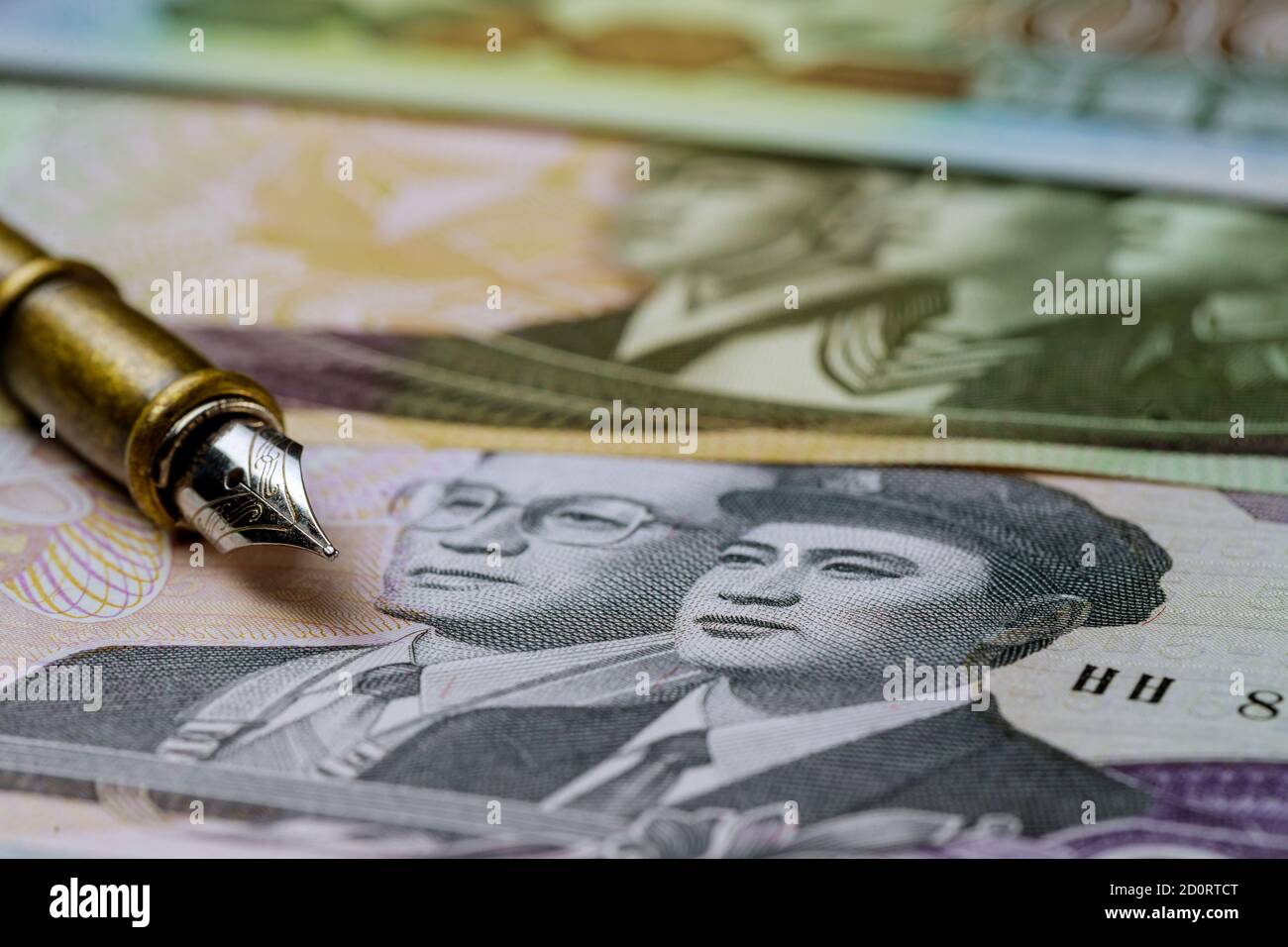 Various banknotes of North Korean won KPW , currency bill over pen for ...