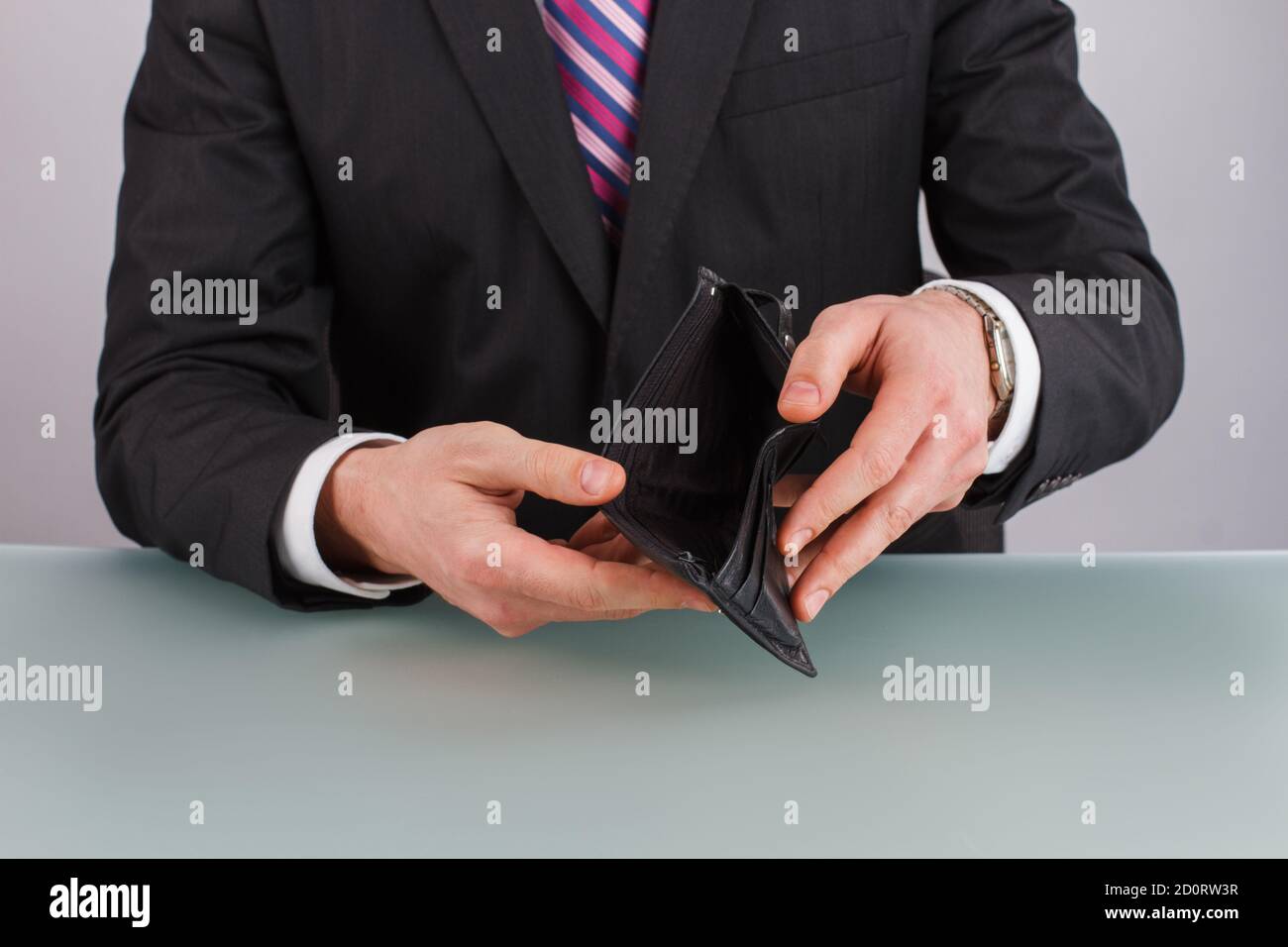 Business person holding an empty wallet Stock Photo - Alamy
