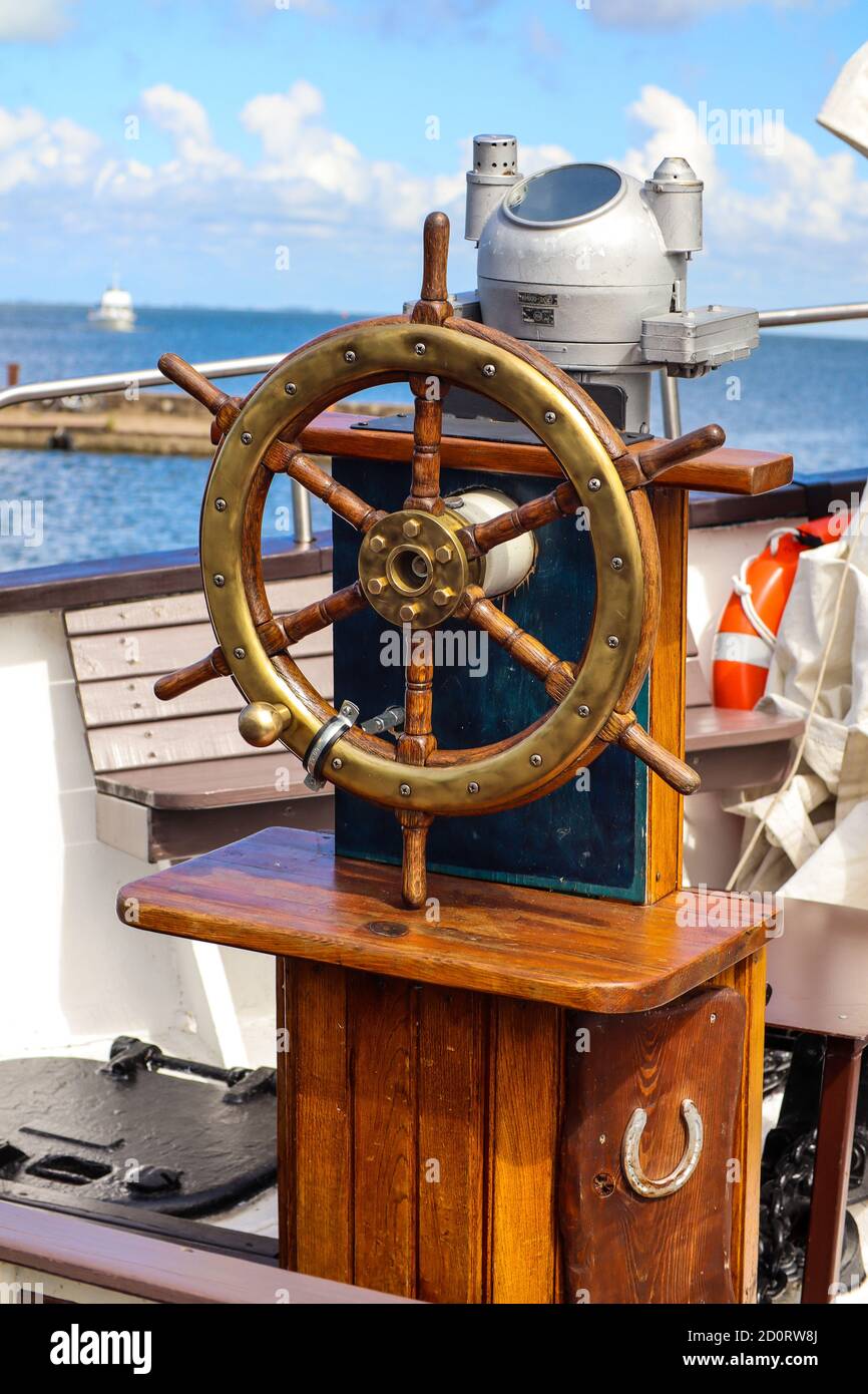 Ship helm on deck with a stand Stock Photo - Alamy