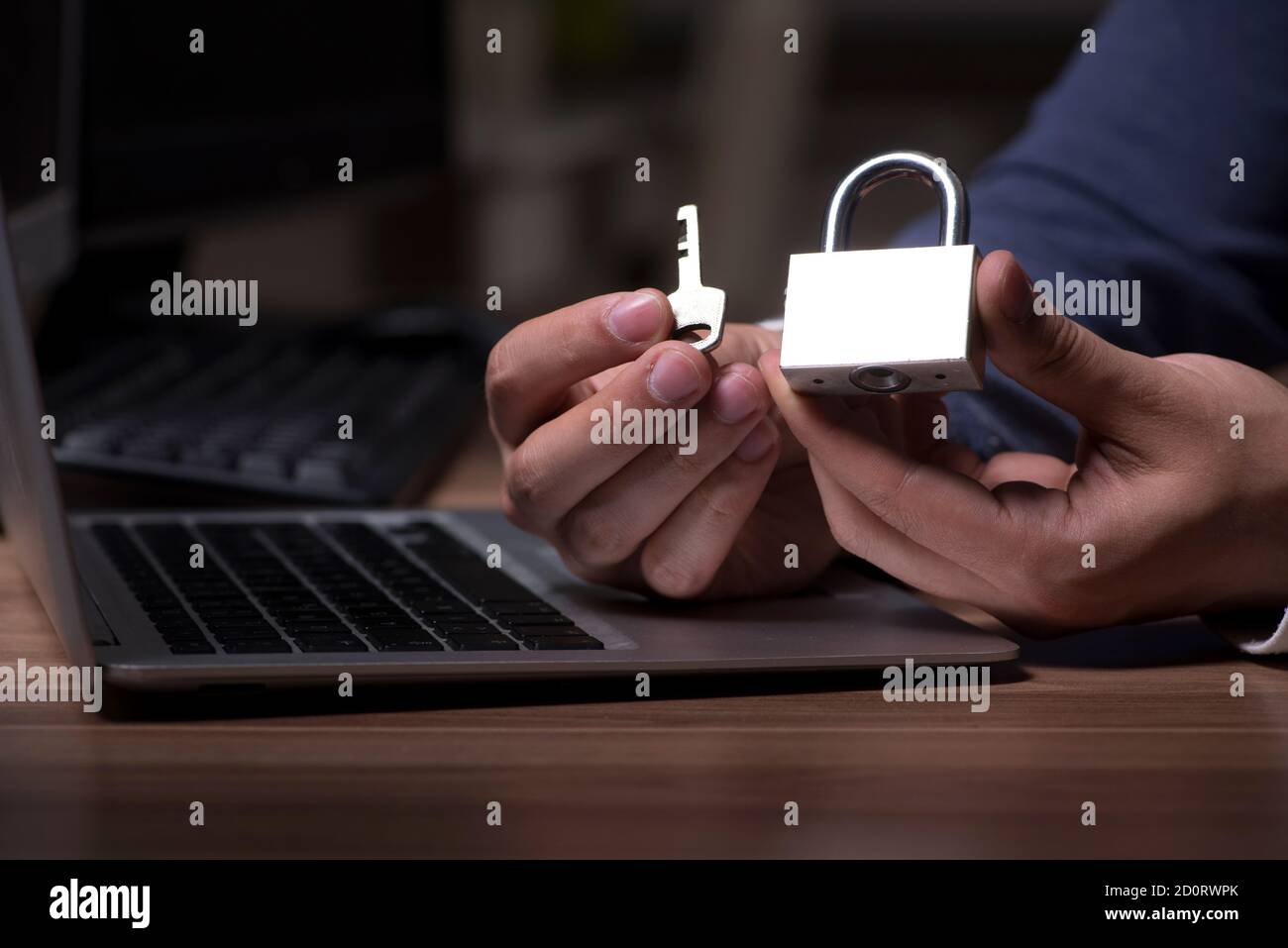 Male hacker hacking security firewall late in the office Stock Photo ...