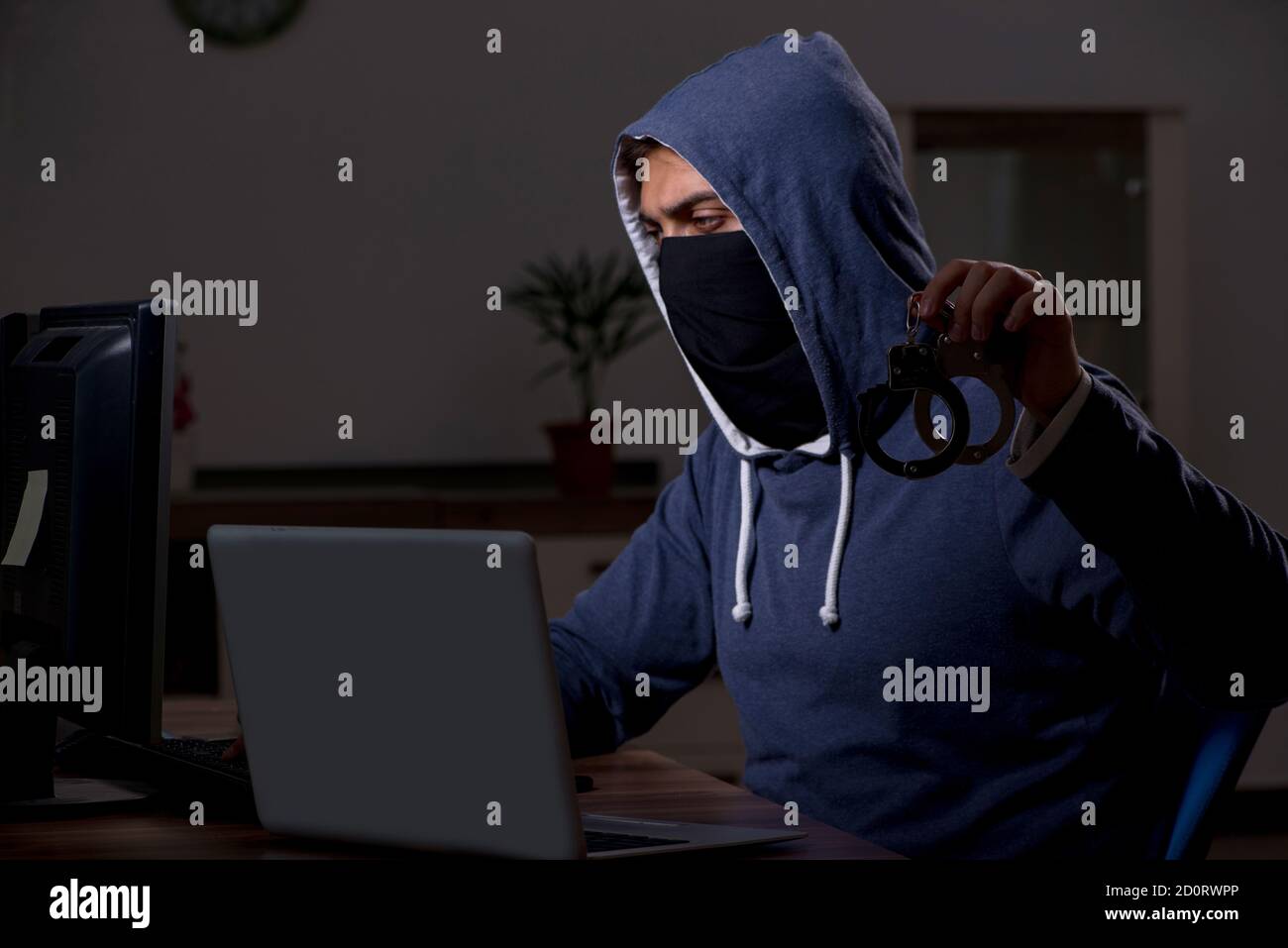 Male hacker hacking security firewall late in the office Stock Photo ...