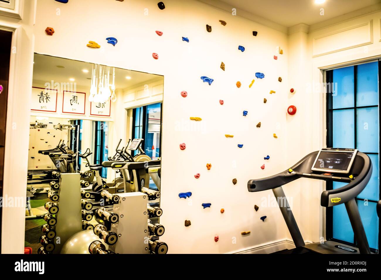 Indoor gym with running machine dumbbells and indoor rock climbing wall ...