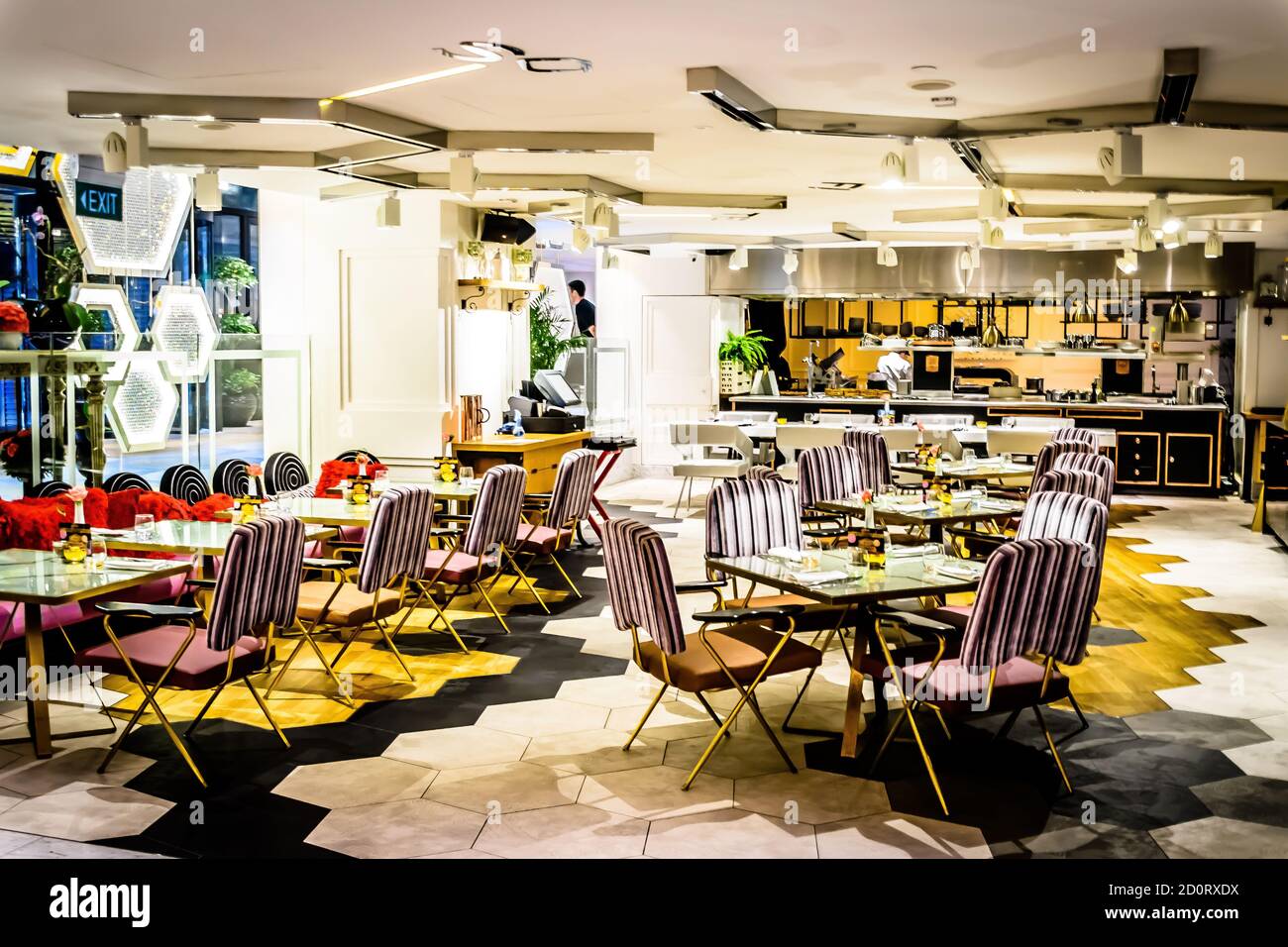 beautiful interior of a restaurant with tables and arm chairs seating ...