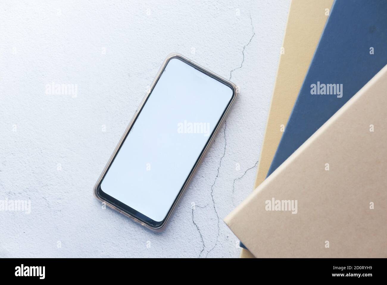 flat composition of smart phone and stack of books Stock Photo - Alamy