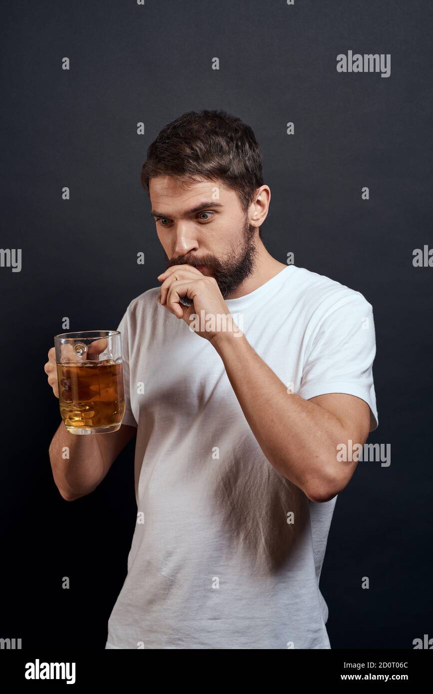 Man with a mug of beer in his hands emotions fun lifestyle white t ...