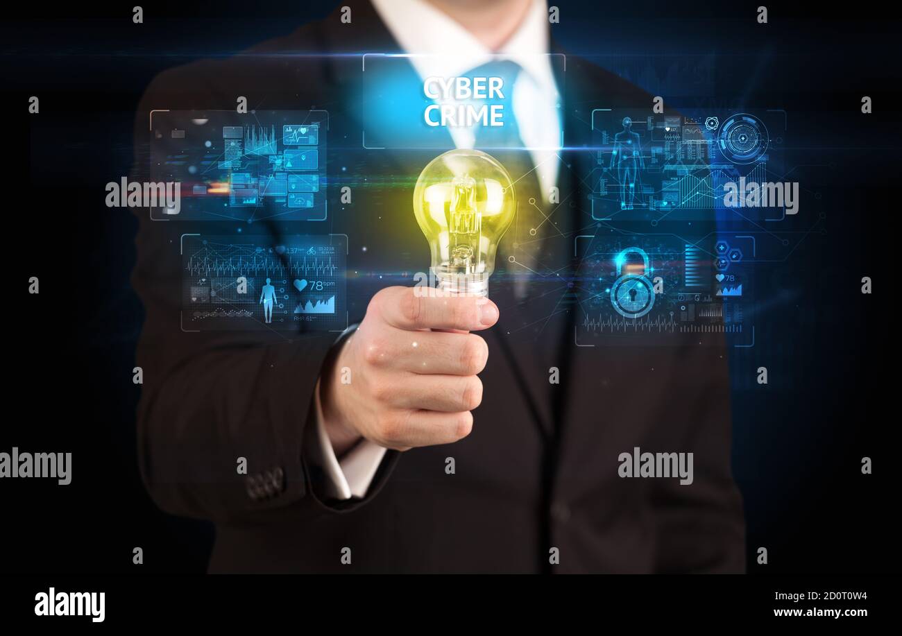 Businessman holding lightbulb with CYBER CRIME inscription, online ...