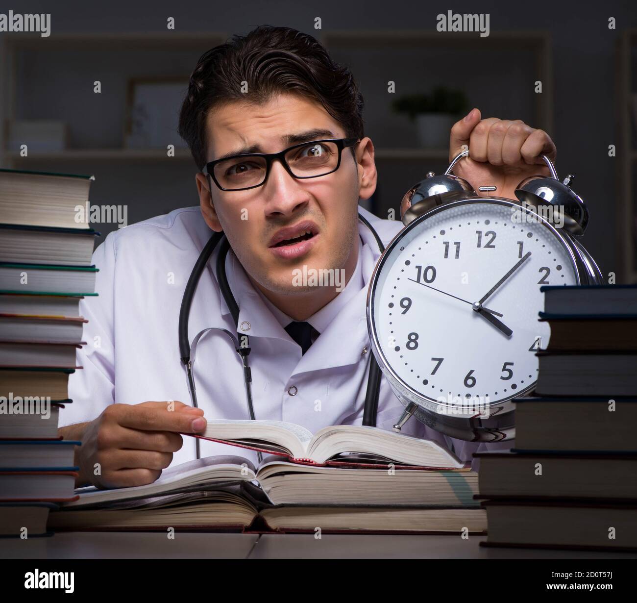 The medical student preparing for university exams at night Stock Photo ...