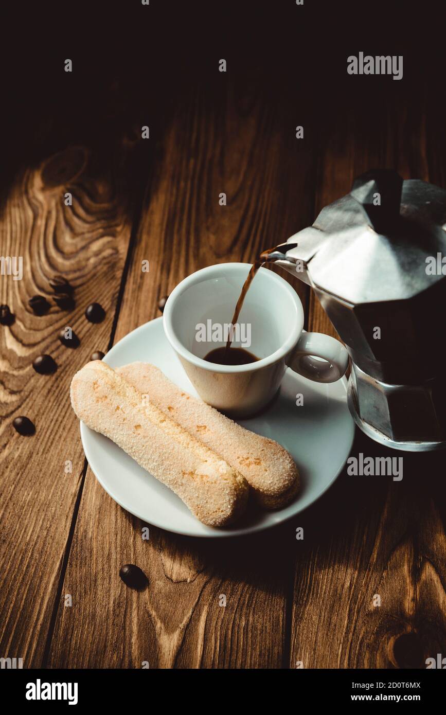 Pouring coffee out of italian coffee pot Stock Photo - Alamy