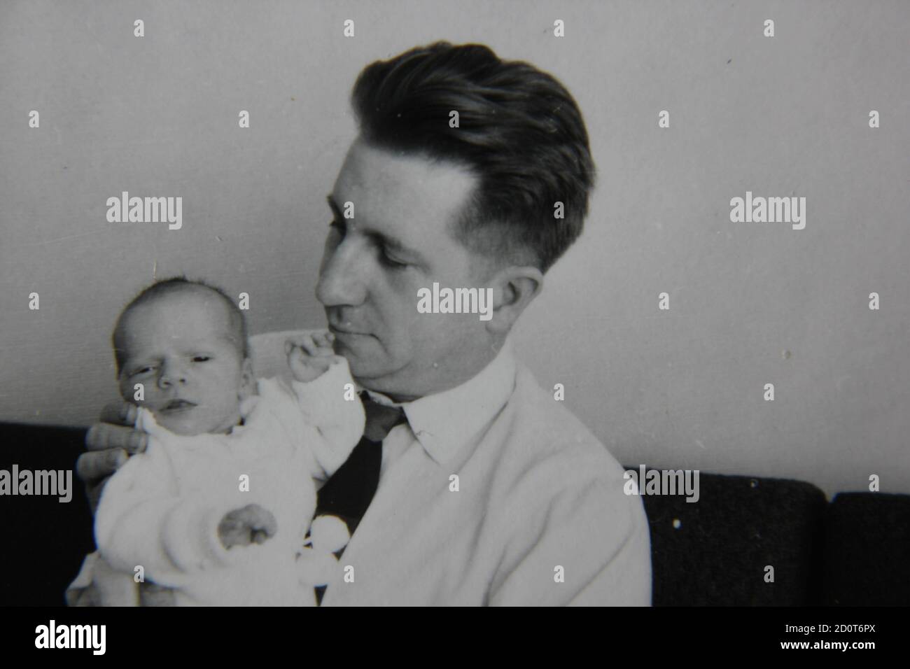 Fine 1970s vintage black and white photography of a new father enjoying ...