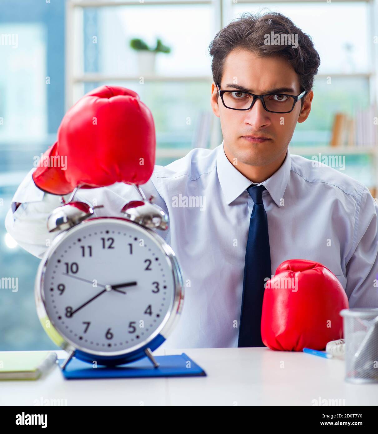 The businessman with boxing gloves in the office Stock Photo - Alamy